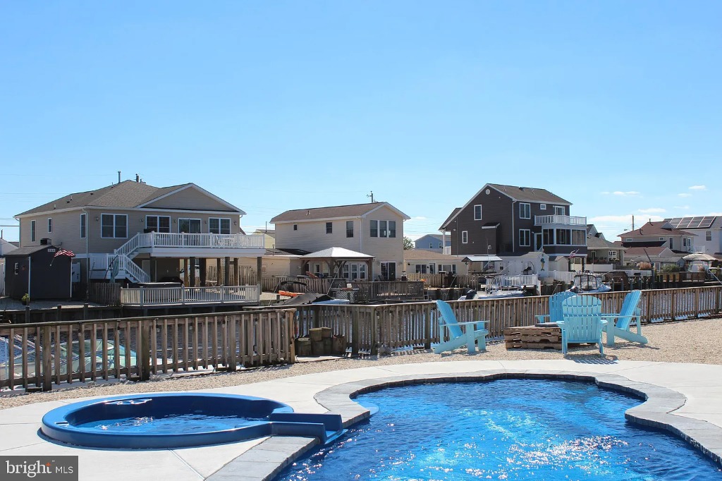 Waterfront with heated pool, hot tub, and fire-pit!